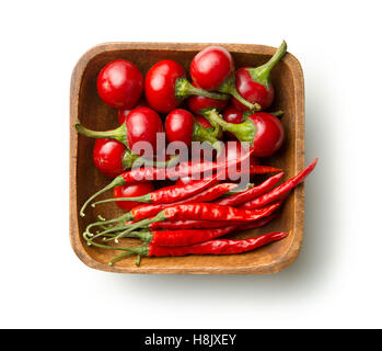 Fresh red chili peppers round slices on wooden cutting board at ...