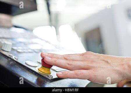 Person finger pressing an on off button on a beige fridge. Close-up ...
