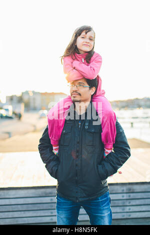 Father carrying daughter in his hands protecting her Stock Photo - Alamy