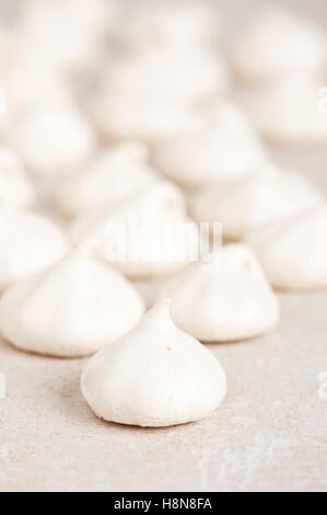 Small white meringues on the table. Selective focus Stock Photo - Alamy