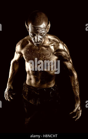 Metallic body painted futuristic alien style muscular man looking angry ...
