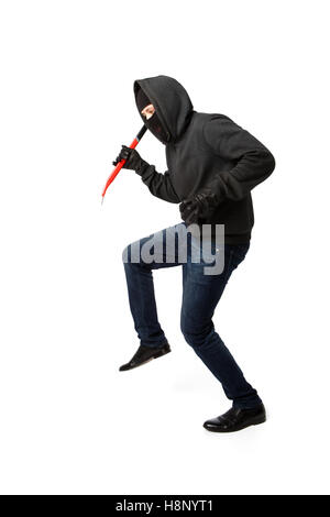 Robber sneaks in black mask Stock Photo - Alamy