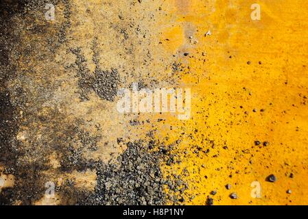 Weathered industrial yellow metal with gravel Stock Photo - Alamy