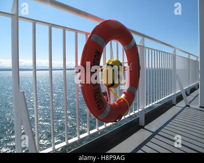 Orange life saver ring on the railing of a ship Stock Photo - Alamy
