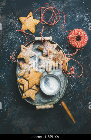 Star and snowflake shaped sugar cookies on a vintage platter with ...