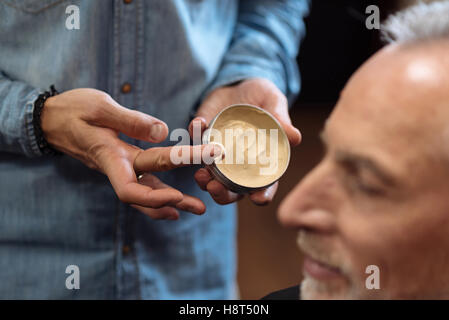 Young man with beard holding jar of chocolate chips cookies looking ...