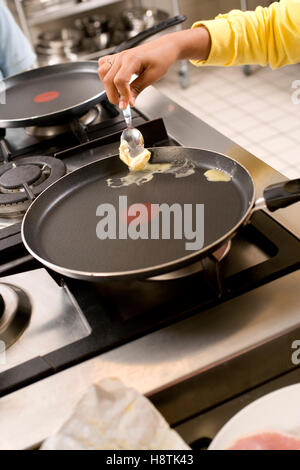 An egg frying in butter and oil in a carbon steel skillet Stock Photo ...