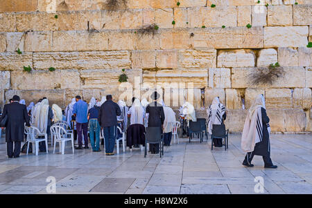 The group of Hasidic Orthodox jewa, dressed in tallits, pray at the ...