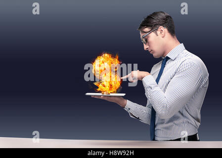 Businessman holding burning american dollar sign Stock Photo - Alamy
