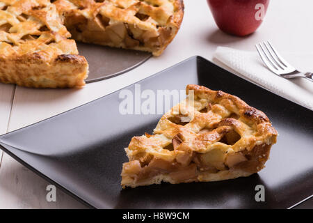 fresh baked apple pie slice on rustic table setting with ingredients ...
