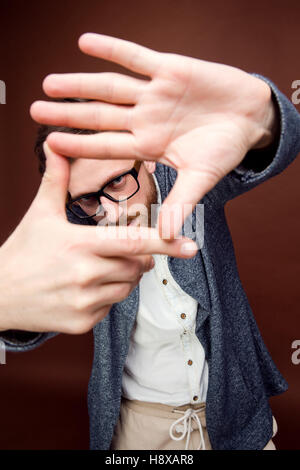 Male making camera from hands Stock Photo - Alamy