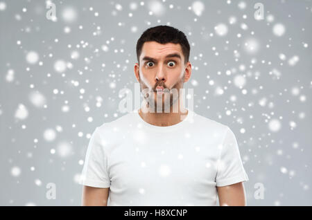 Winter holidays and christmas. Confused guy in sweater pointing at ...