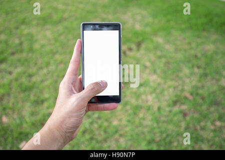 Mans hand hold and touch screen smart phone, blur on the road high way ...