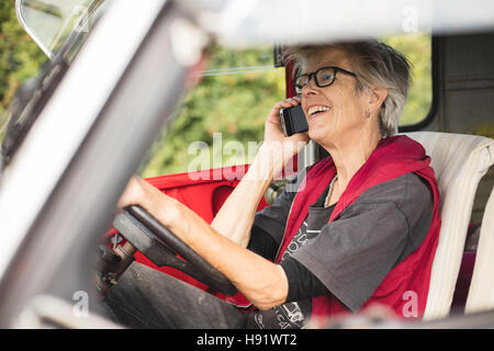 Elderly car mechanic making a phone call Stock Photo - Alamy