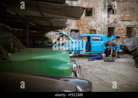 Cuban car mechanic repairing 1950s vintage American Chrysler pickup ...