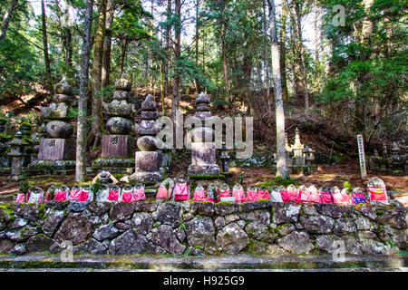 Row of five-stone towers, gorinto, among tall cedar trees in the ...