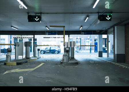 Exit lane of a parking garage with barrier and ticket machines Stock ...