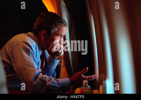 George W. Bush talks on the telephone at his office desk at Arbusto ...