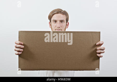 Young bearded man with big paper heart for Valentine's Day on pink ...