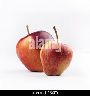 Big and small apples. Two ripe apples, red and green isolated on white ...