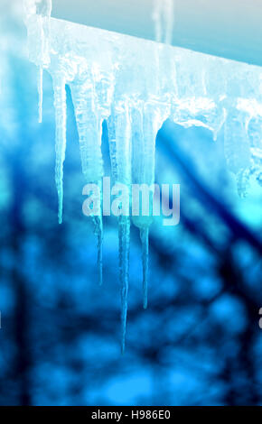 Icicles hang on the roof in winter. Selective focus. nature Stock Photo ...