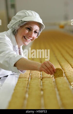 Large biscuit factory. A line of biscuits in a large factory. Packing ...