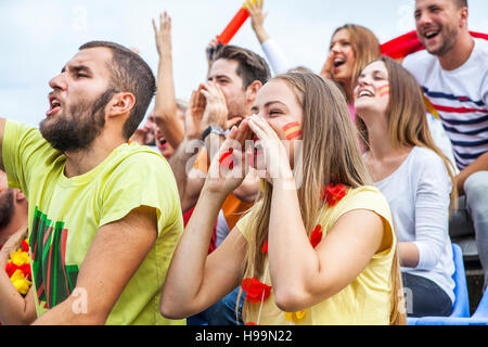 Group of soccer fans shouting in stadium Stock Photo - Alamy