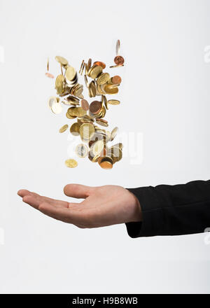 Hand throwing coins Stock Photo - Alamy