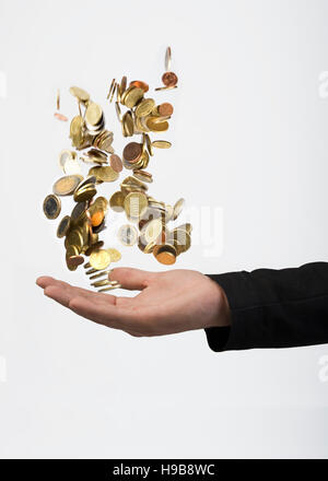 Hand throwing coins Stock Photo - Alamy