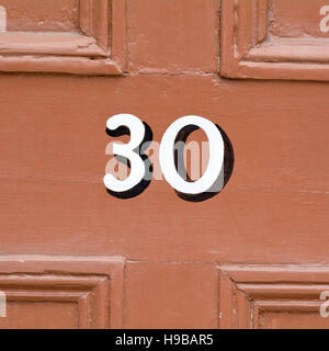 House number 30 sign painted gold on red brick wall Stock Photo - Alamy