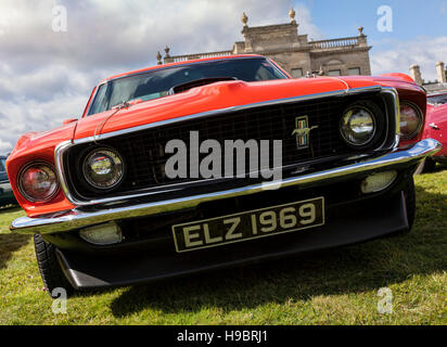 Classic red ford mustang mach 1 parked in front of a stone wall ...