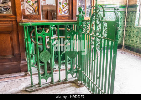 A green old fashioned turnstile allowing people into a building Stock ...
