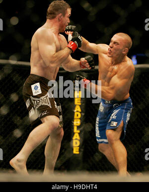 Georges St. Pierre, right, punches Matt Hughes during Ultimate Fighting ...