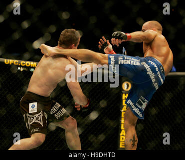 Georges St. Pierre, right, kicks Matt Hughes during Ultimate Fighting ...