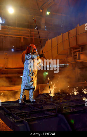 worker and production of cast iron inside of steel plant Stock Photo ...