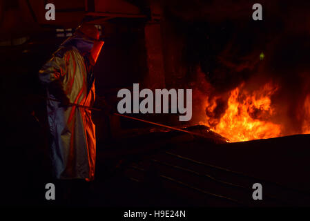 worker and production of cast iron inside of steel plant Stock Photo ...