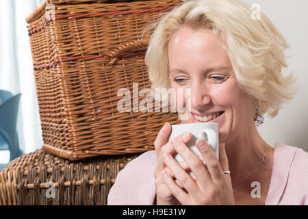 Woman smiles, holding drink in traditional Korean attire. Bright colors ...