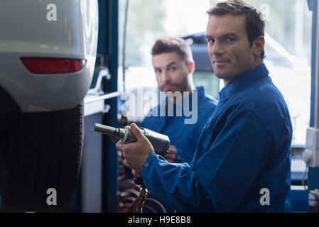 Mechanic changing a wheel of a modern car (color toned image Stock ...