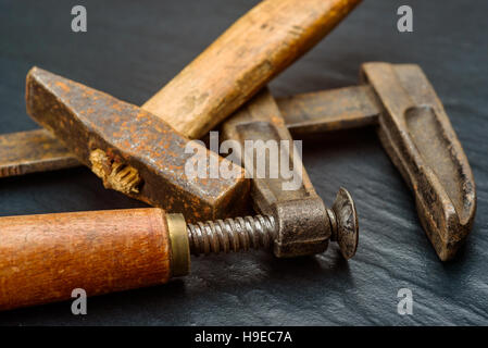 Old and well used handmade square hammer with short wooden handle and ...