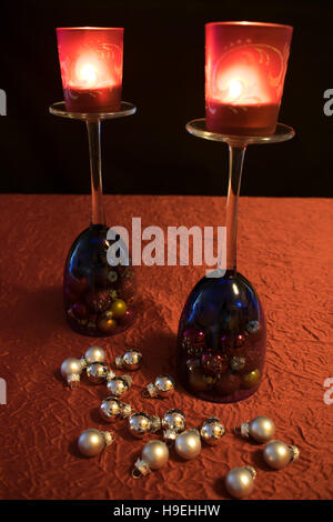Glass of red wine with Christmas balls on light table, closeup Stock ...
