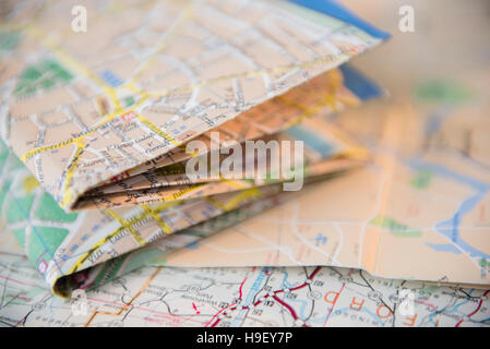 stack pile of travel maps on shelf Stock Photo - Alamy