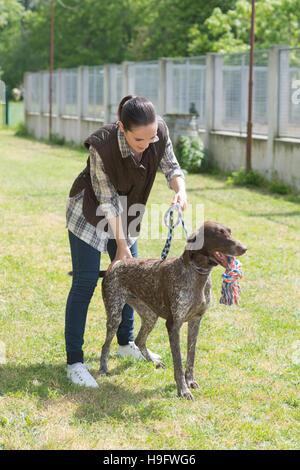 dedicated girl training dog in kennel Stock Photo - Alamy