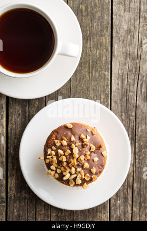 Top view of a cup of coffee with a plate of butter cookies on wooden ...
