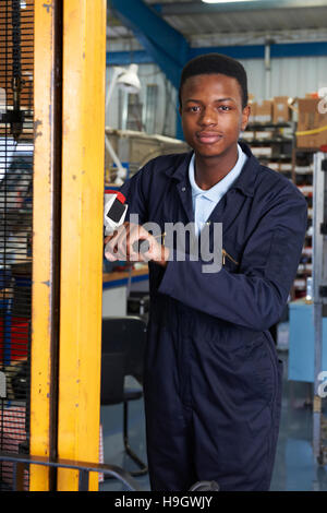 Factory Worker Using Powered Fork Lift To Load Goods Stock Photo - Alamy