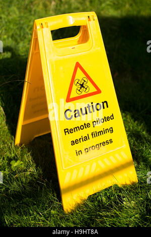 Caution filming in progress sign signage near a film set in Surrey, UK ...