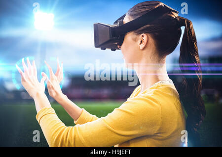 Composite image of woman using an oculus Stock Photo - Alamy