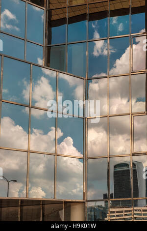 Reflection of a cloudy sky in glass wall of an office building Stock ...