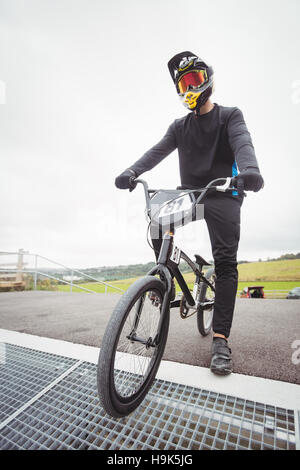Cyclist preparing for BMX racing at starting ramp Stock Photo - Alamy