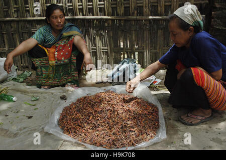 Bangladeshi tribal women sell traditional local food in Bandarban ...