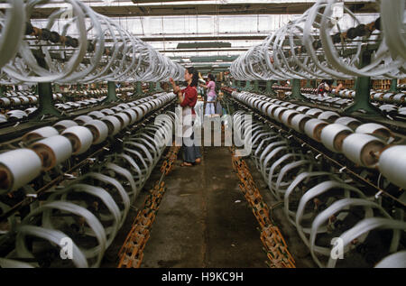 Spools of silk being put on to bobbins ready for weaving in the Chinese ...